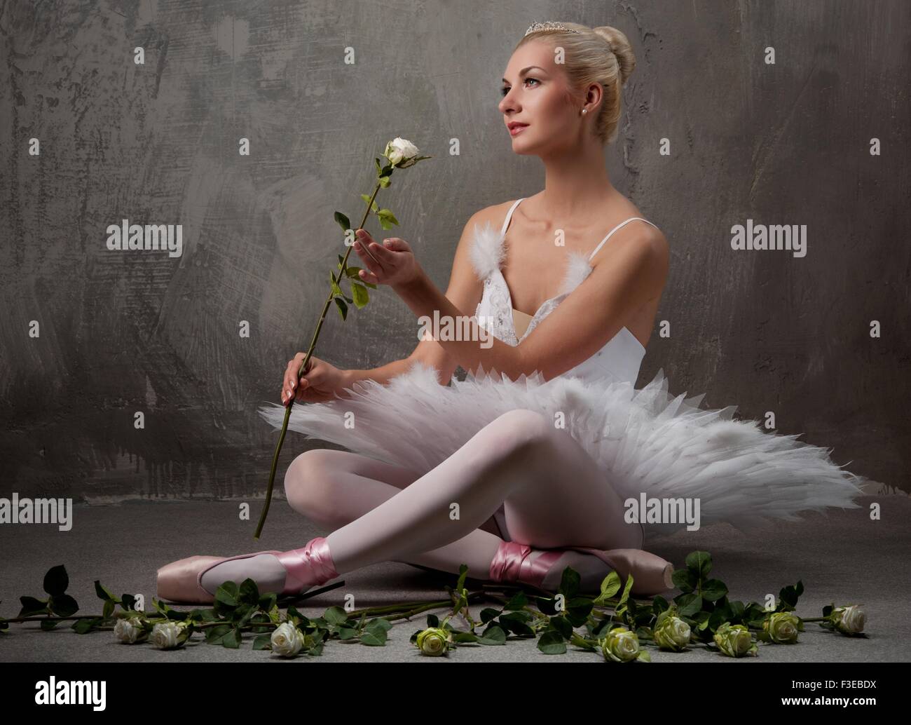 Beautiful ballet dancer with a white roses Stock Photo - Alamy