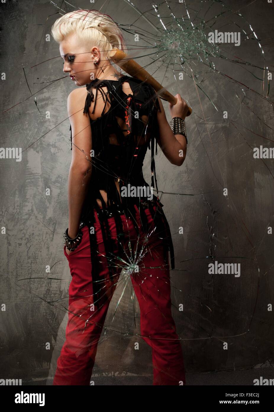 Punk girl behind broken glass Stock Photo - Alamy