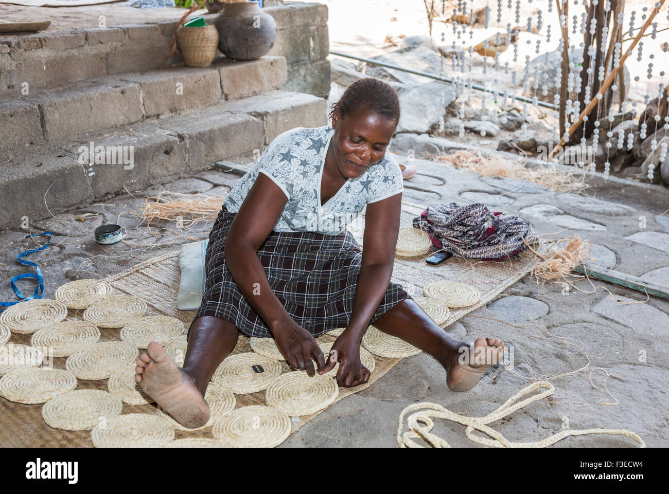 Local crafts: African woman working making a woven mat, Katundu ...