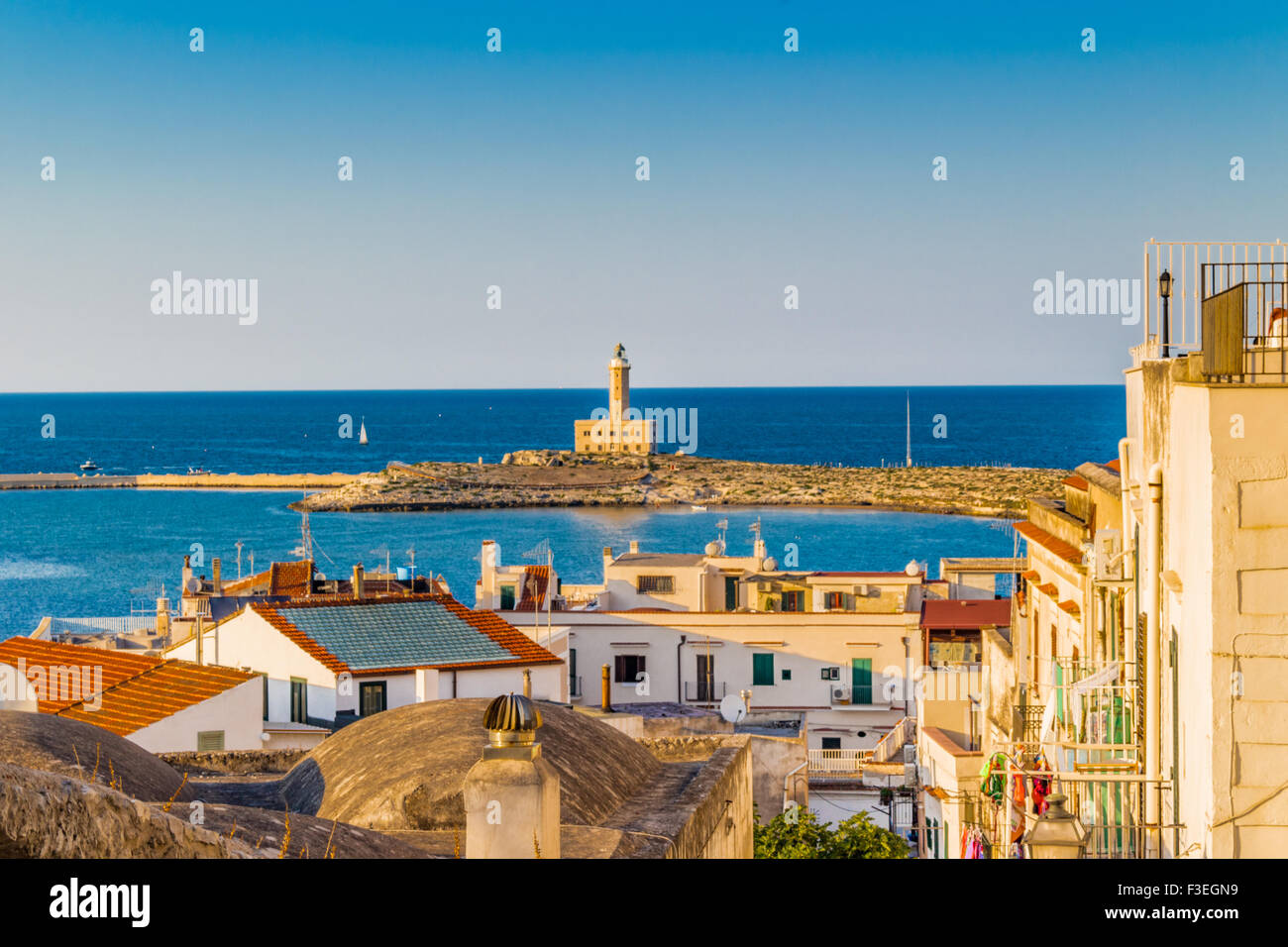 Vieste lighthouse protecting ancient houses and buildings of the ...