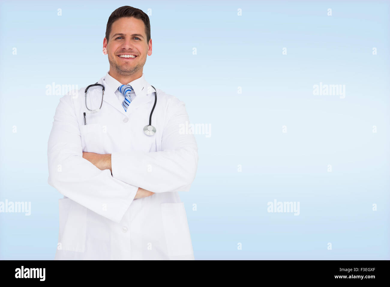 Composite image of handsome doctor with arms crossed Stock Photo - Alamy