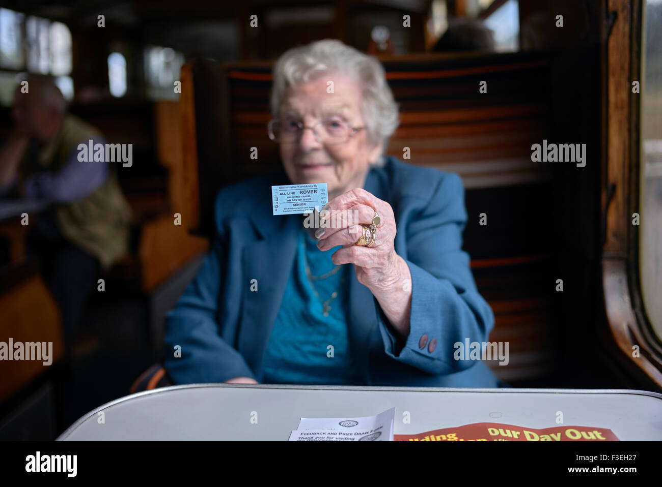 Rail Ticket. Senior woman displaying all day rail ticket aboard the GWR ...