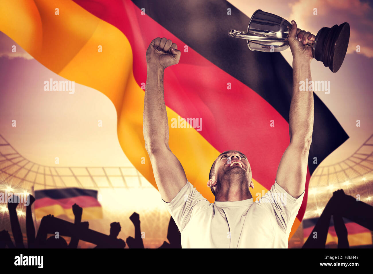 Composite image of happy rugby player holding trophy Stock Photo - Alamy