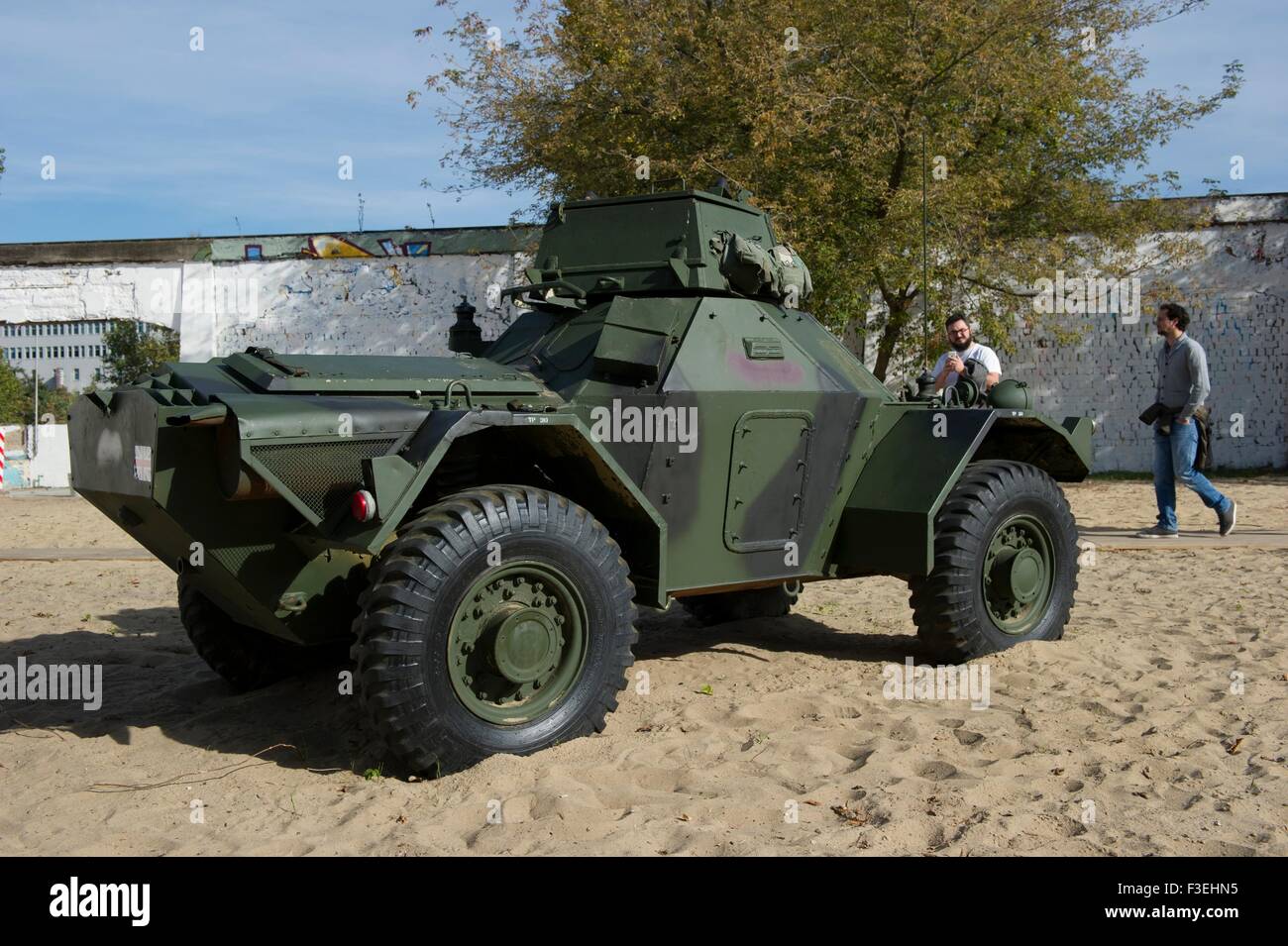 Visitors walk past a tank from the former German Democratic Republic ...