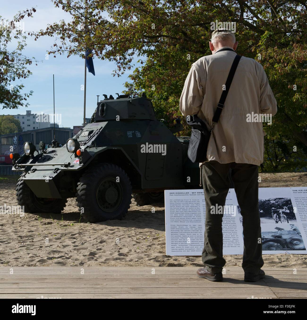 A man stands in front of a tank from the former German Democratic ...