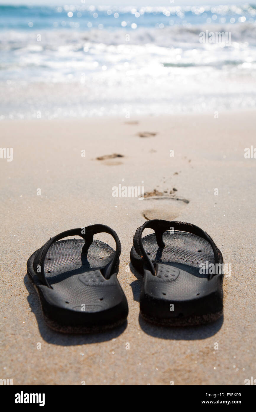 Flip flops on a sand beach Stock Photo - Alamy