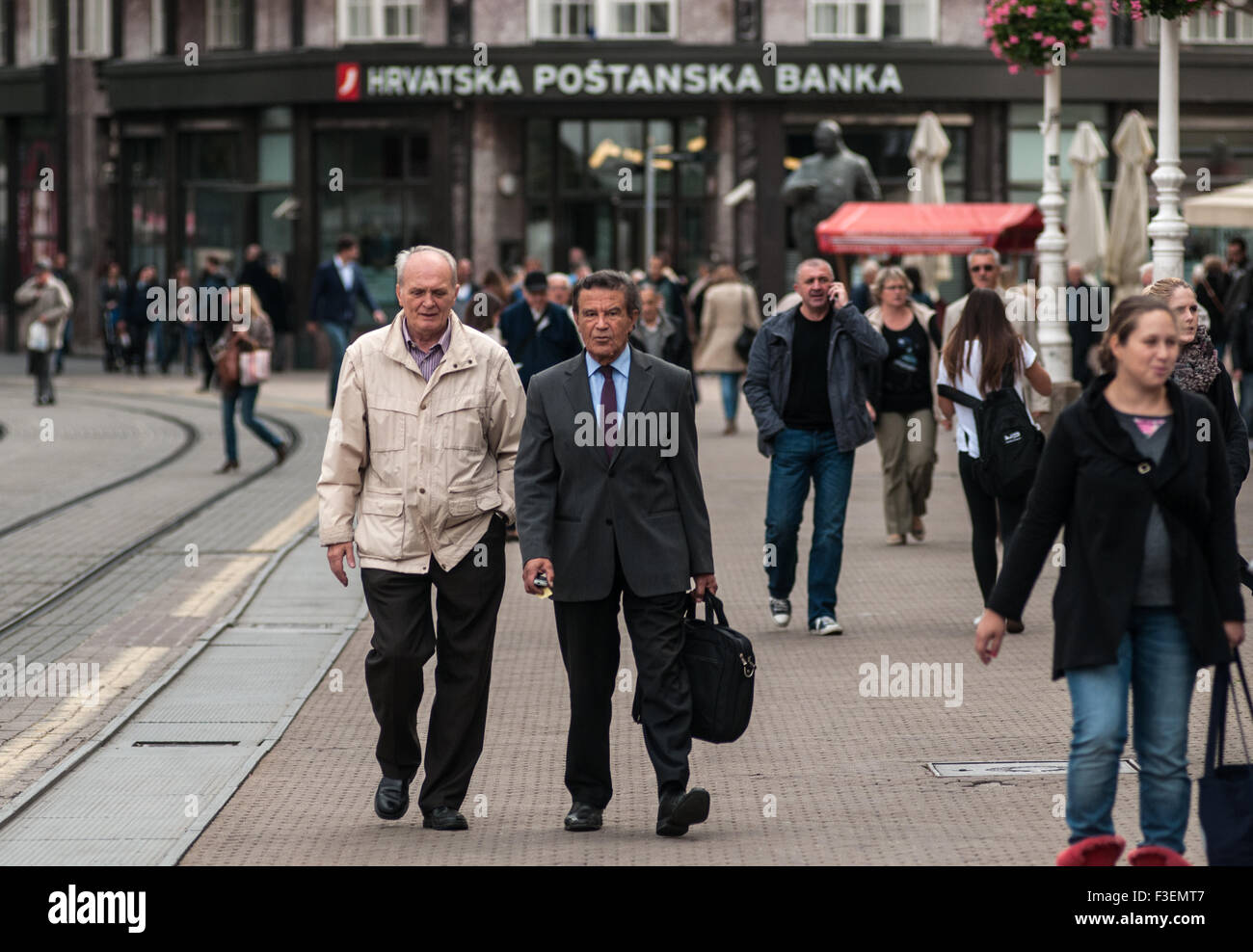 People walking in front of a bank in the center of the city of Zagreb ...