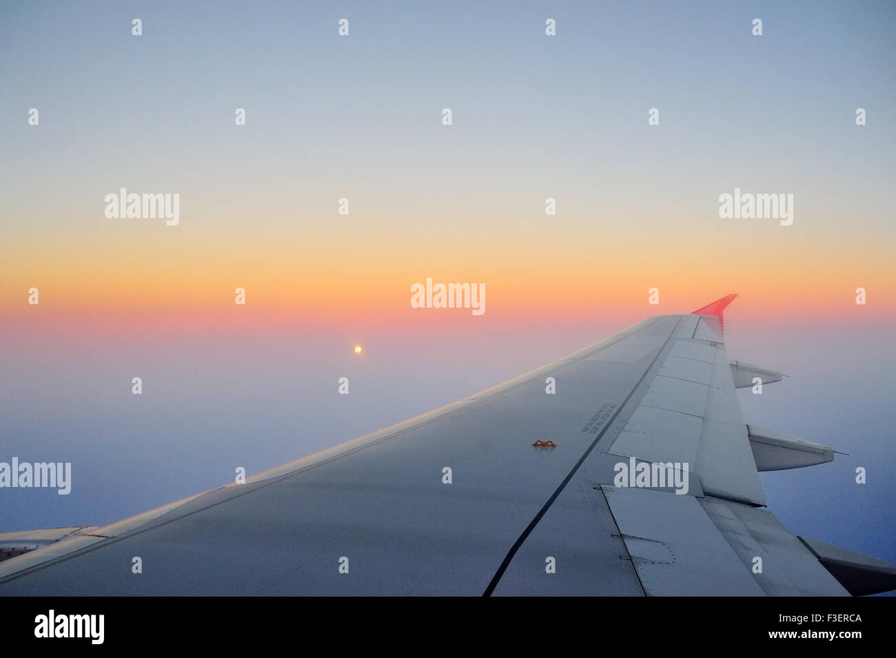 Watch sunset from airplane windows Stock Photo - Alamy