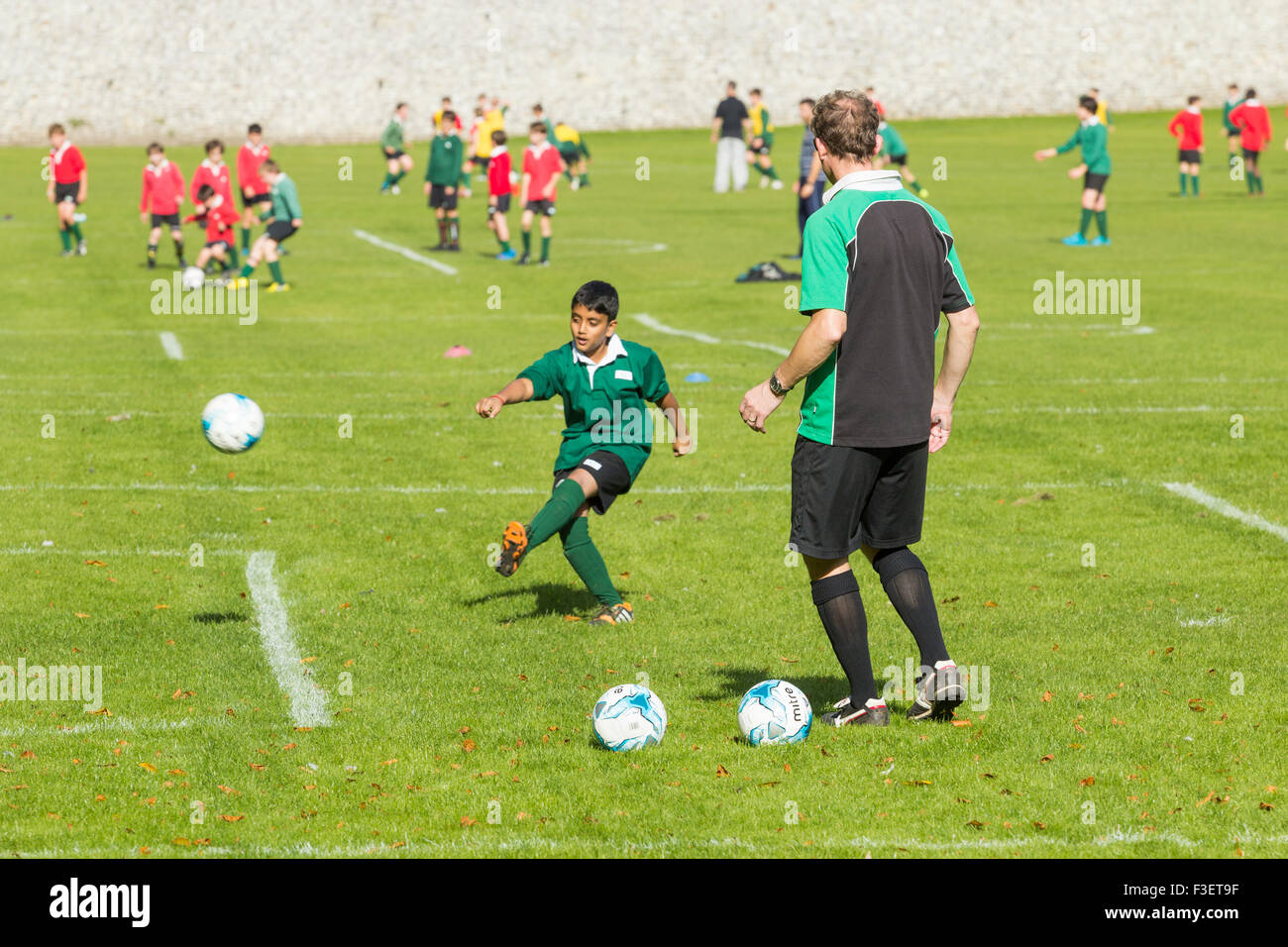 Schoolchildren playing football on private school playing fields in ...