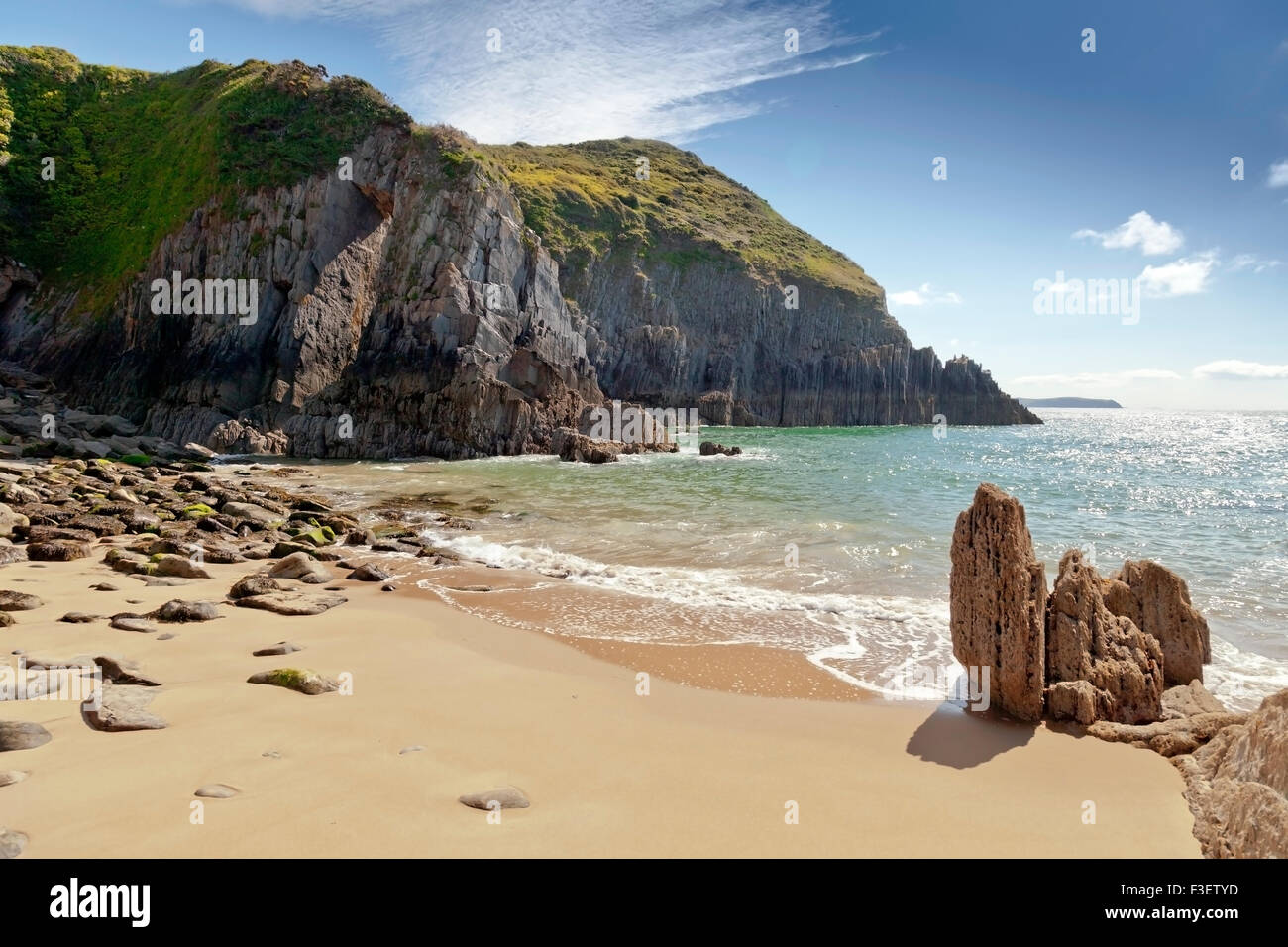 The dramatic coastal scenery and deserted beach at Skrinkle Haven in ...