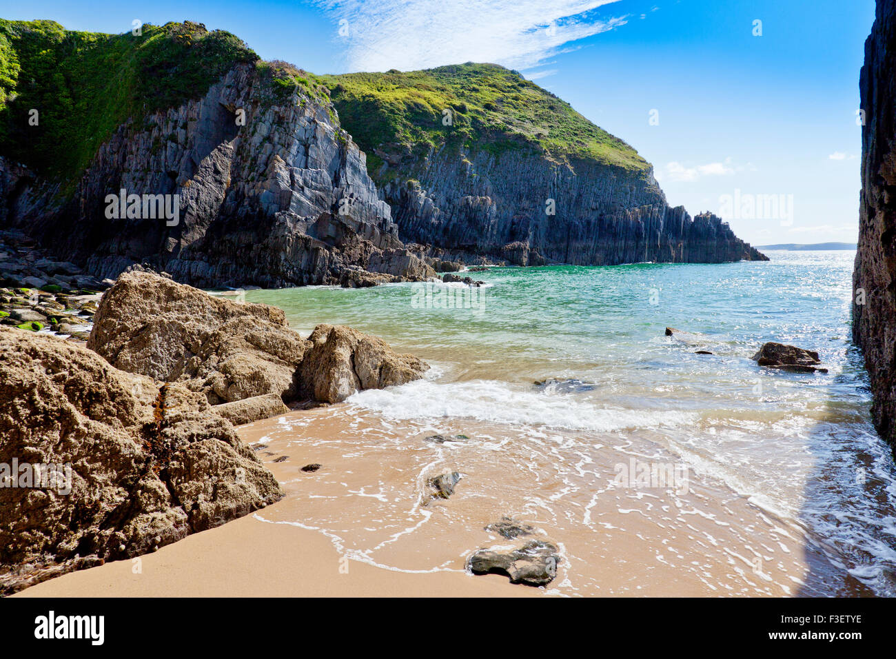 The dramatic coastal scenery and deserted beach at Skrinkle Haven in ...