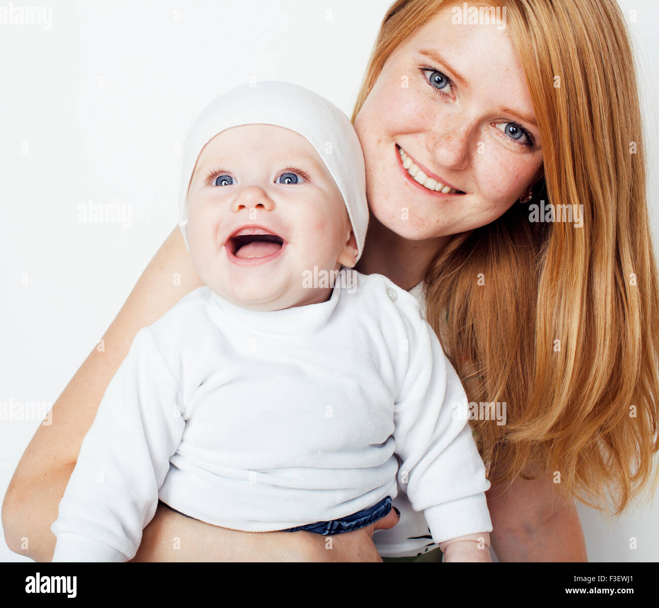 young beauty mother with baby, red head happy family isolated Stock ...