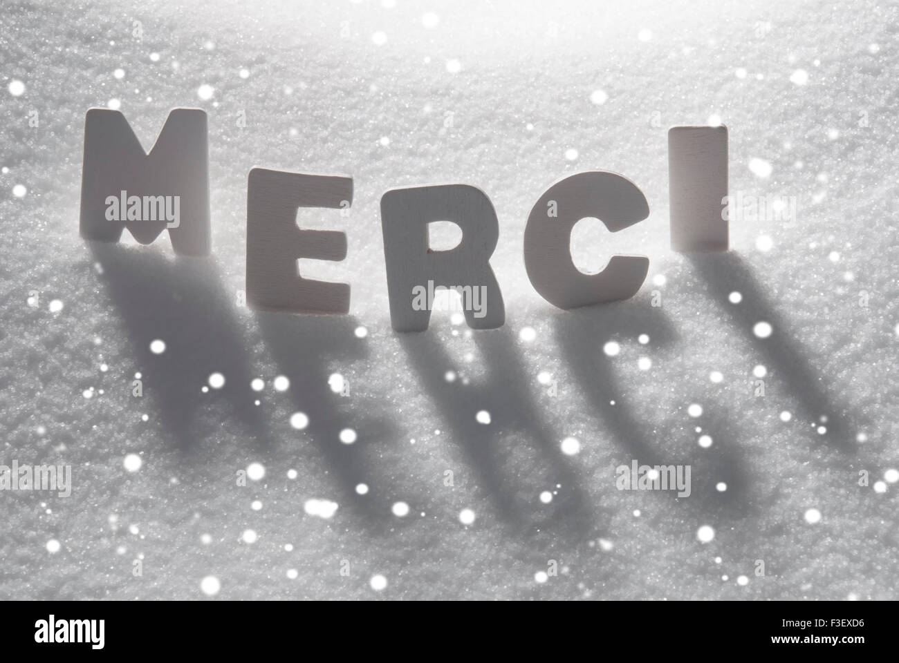 White Word Merci Means Thank You On Snow, Snowflakes Stock Photo - Alamy