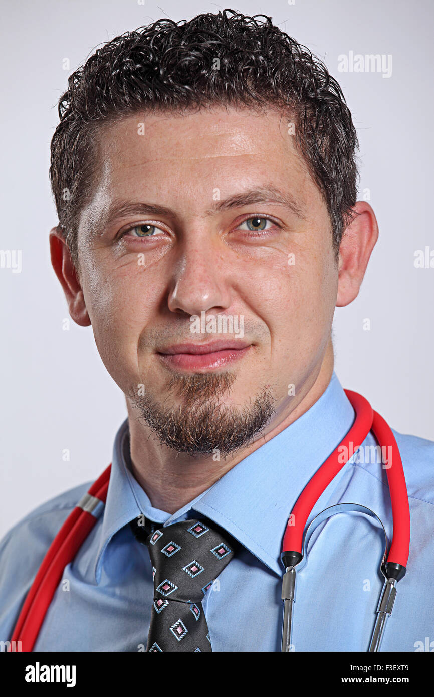 A mature, handsome, smiling doctor wearing his formal work attire Stock ...