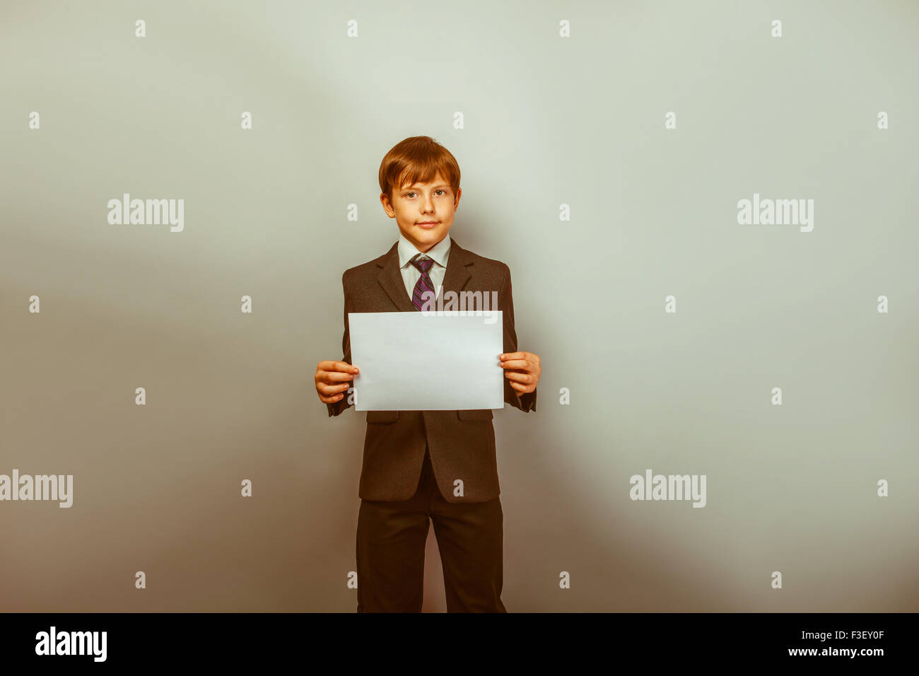 a boy of twelve European appearance in a suit holding a blank sh Stock ...