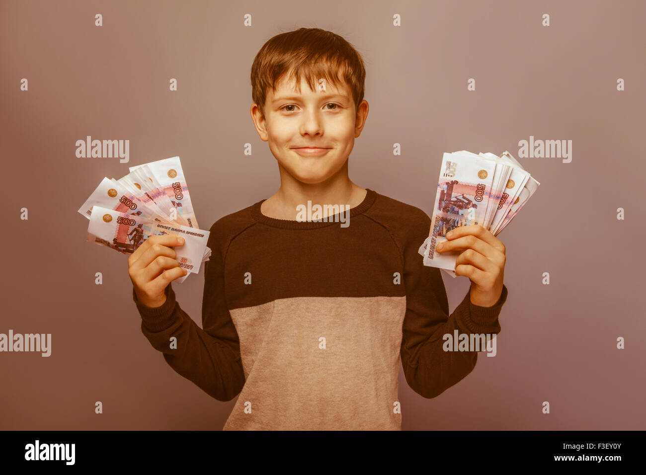 Boy teenager European appearance ten years holding a wad of mo Stock ...
