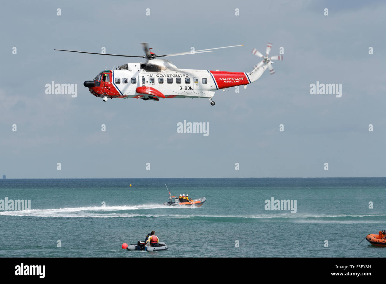 H.M Coastguard search and rescue helicopter and RNLI inshore lifeboat working together on ...