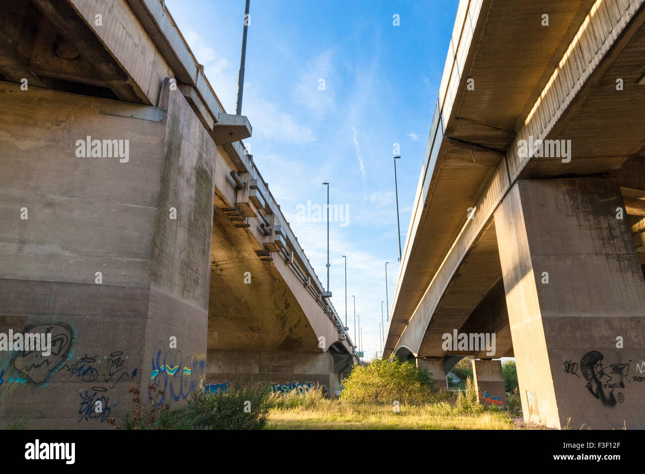 Graffiti on bridge supports underneath two concrete road bridges ...