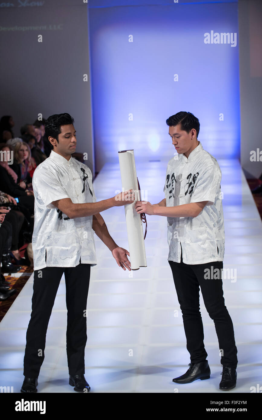 Male models open scroll on the runway in designs by YiLing Li (USA ...