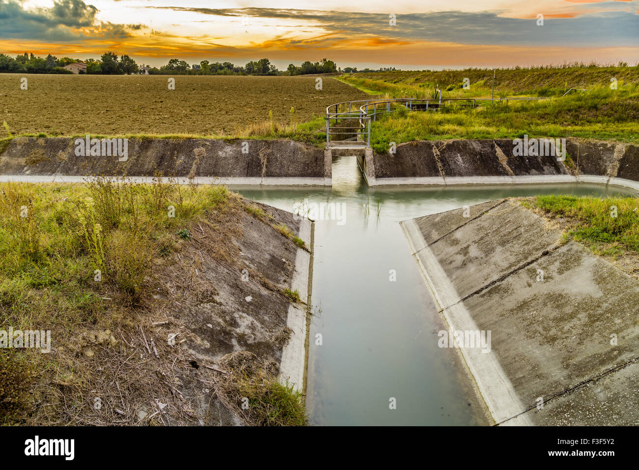 Channel to divert river water for irrigation of cultivated fields Stock ...