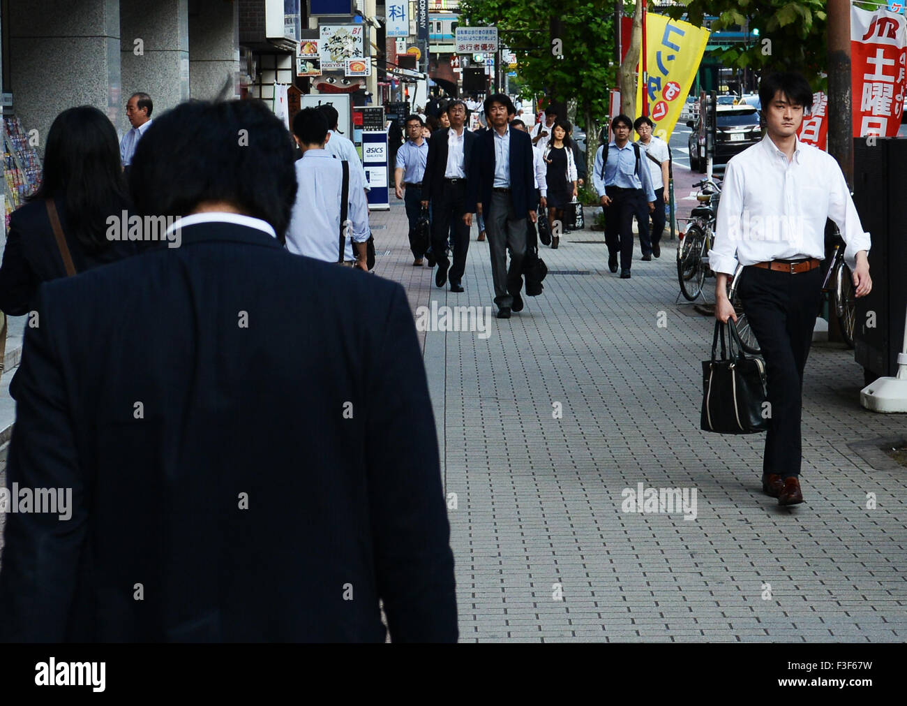 Busy sidewalks. After a long day at work people begin their long ...
