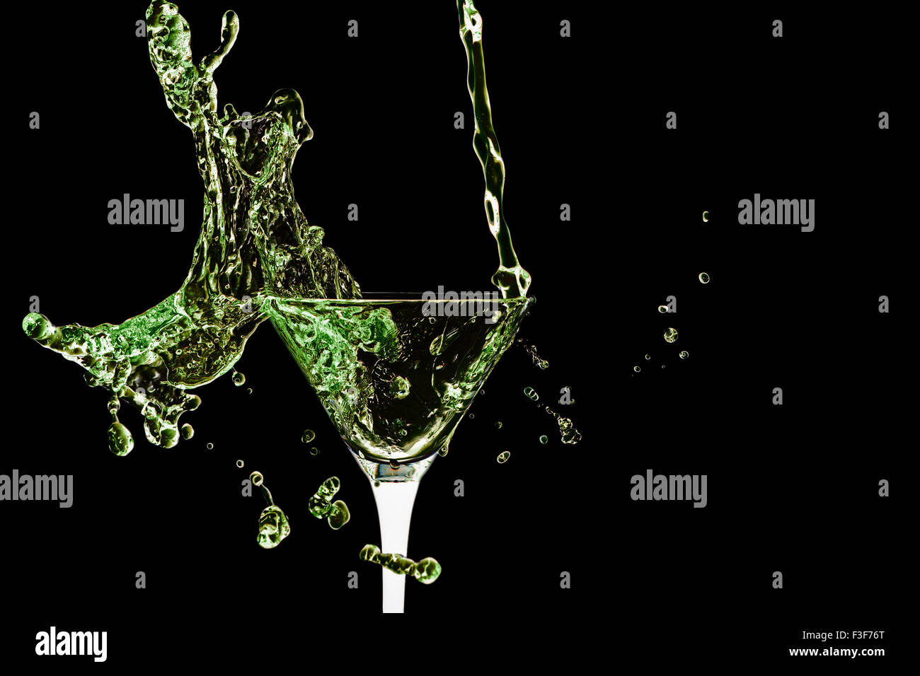 Abstract art. Cocktail glass with splashes of liquid isolated on a ...