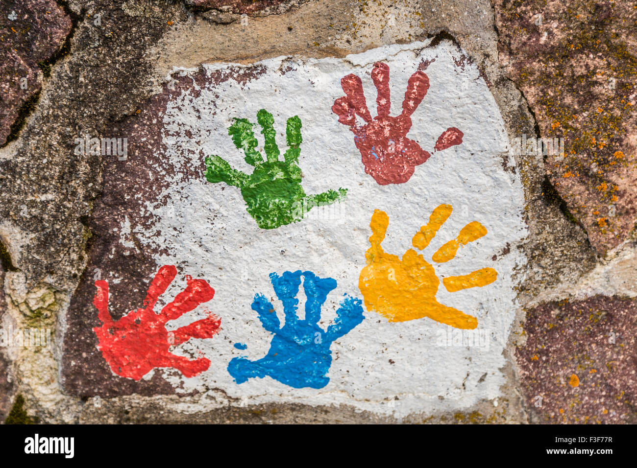 colored prints of children hands on a rock Stock Photo - Alamy