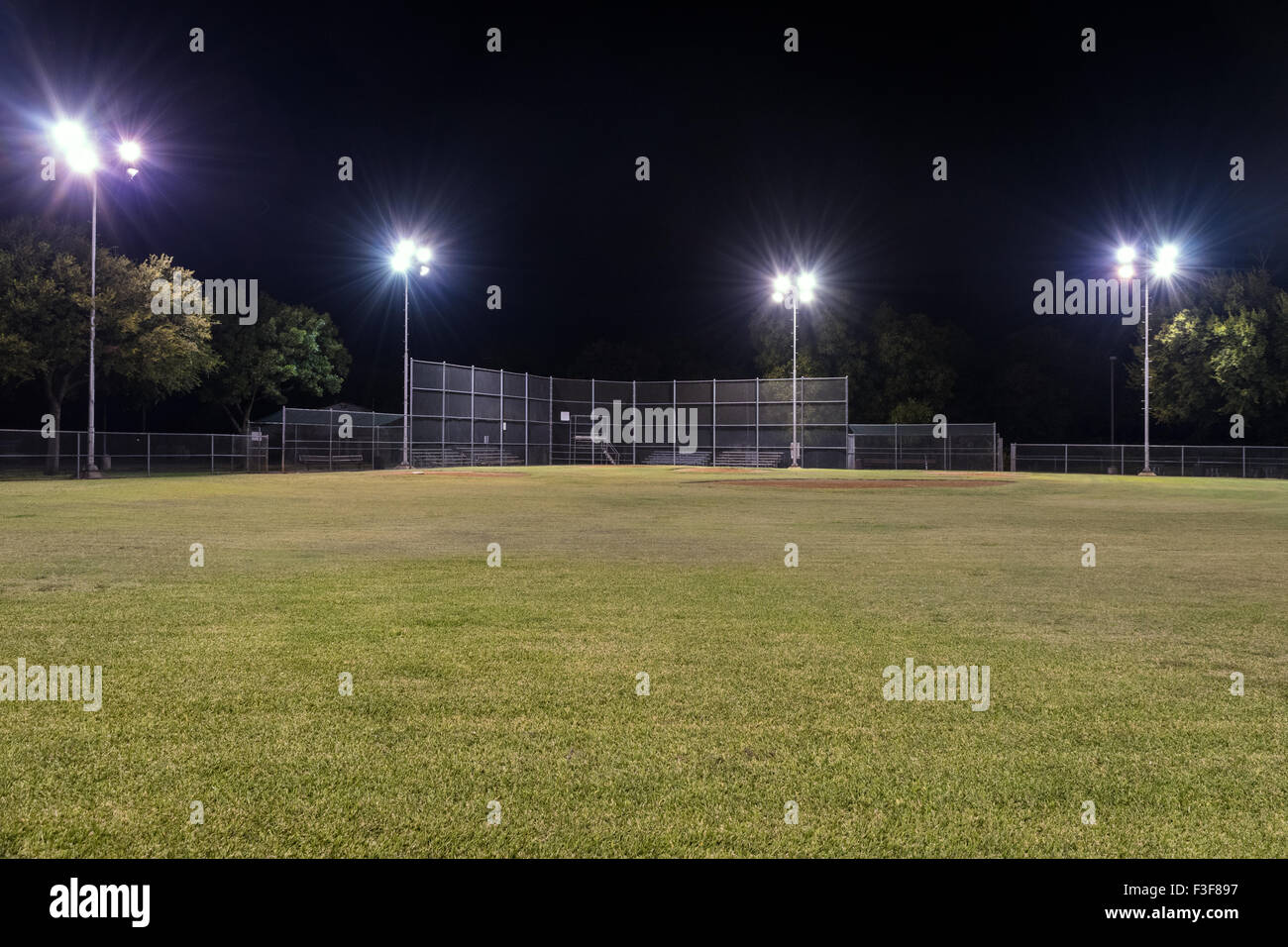 Night photo of an empty baseball field at night looking back toward ...