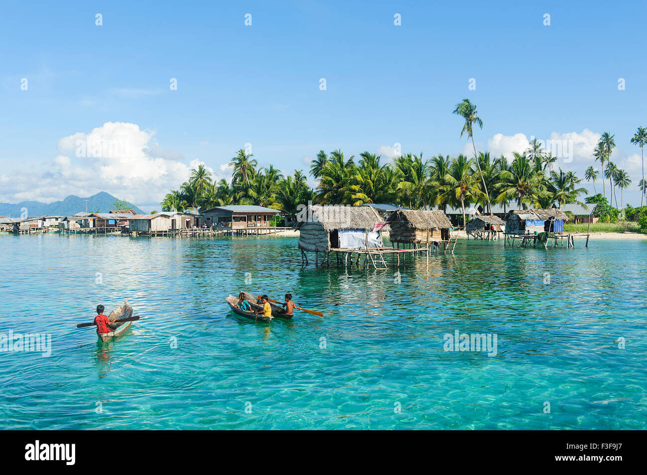 Unidentified Borneo Sea Gypsy kids on a canoes in Mabul Maiga Island ...