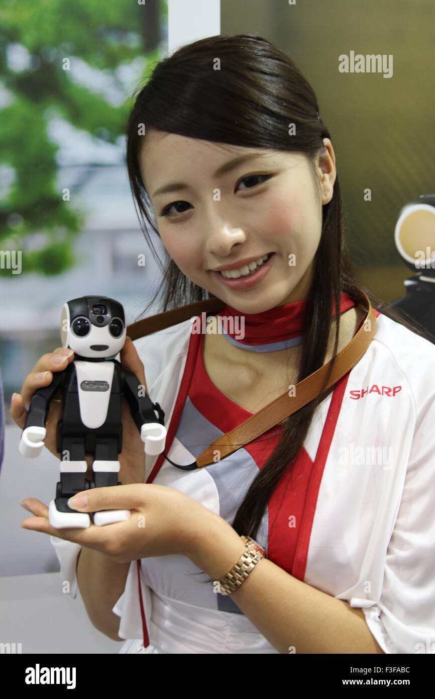 Chiba, Japan. 07th Oct, 2015. A hostess shows off the small RoBoHoN ...