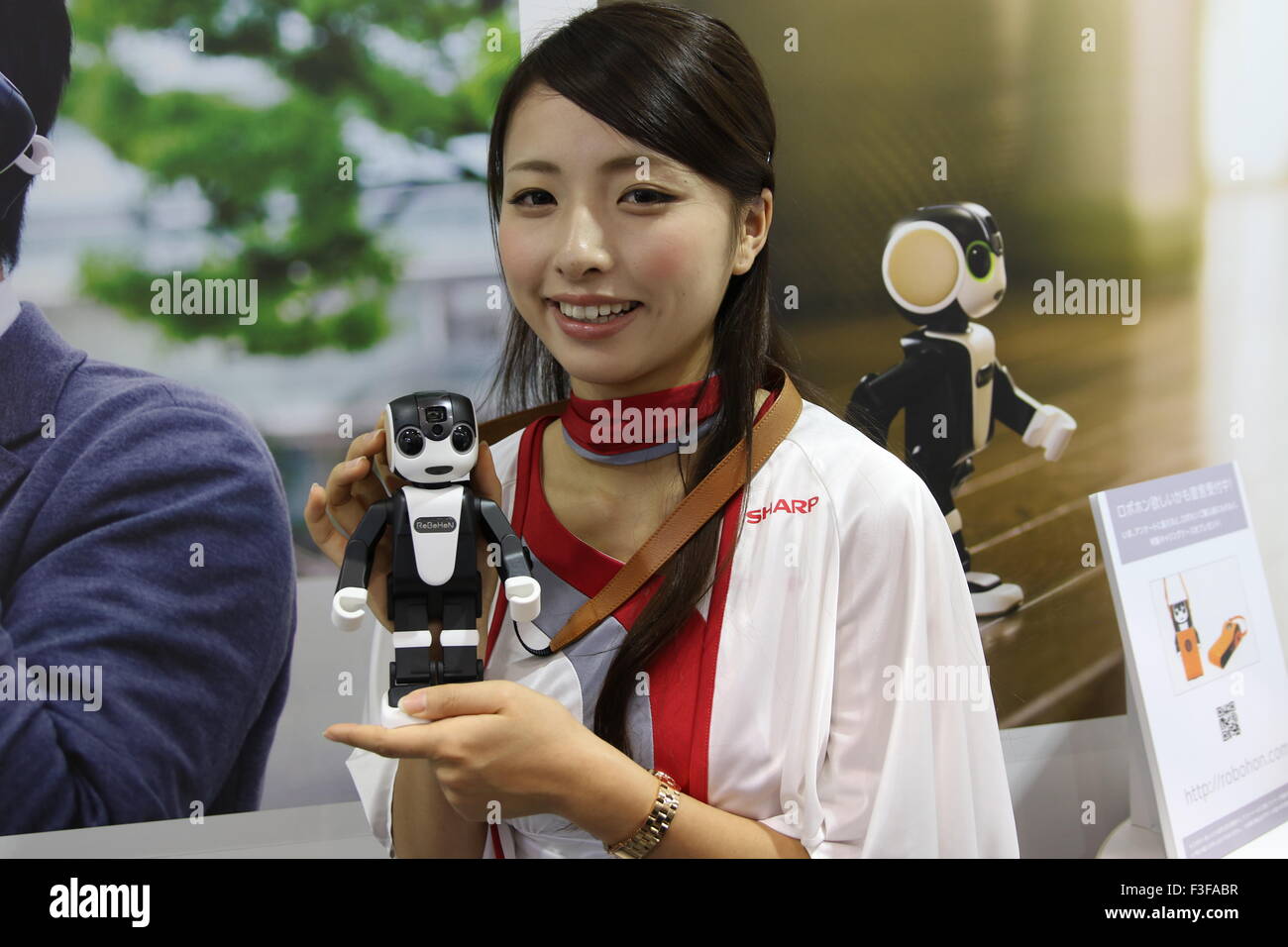 Chiba, Japan. 07th Oct, 2015. A hostess shows off the small RoBoHoN ...