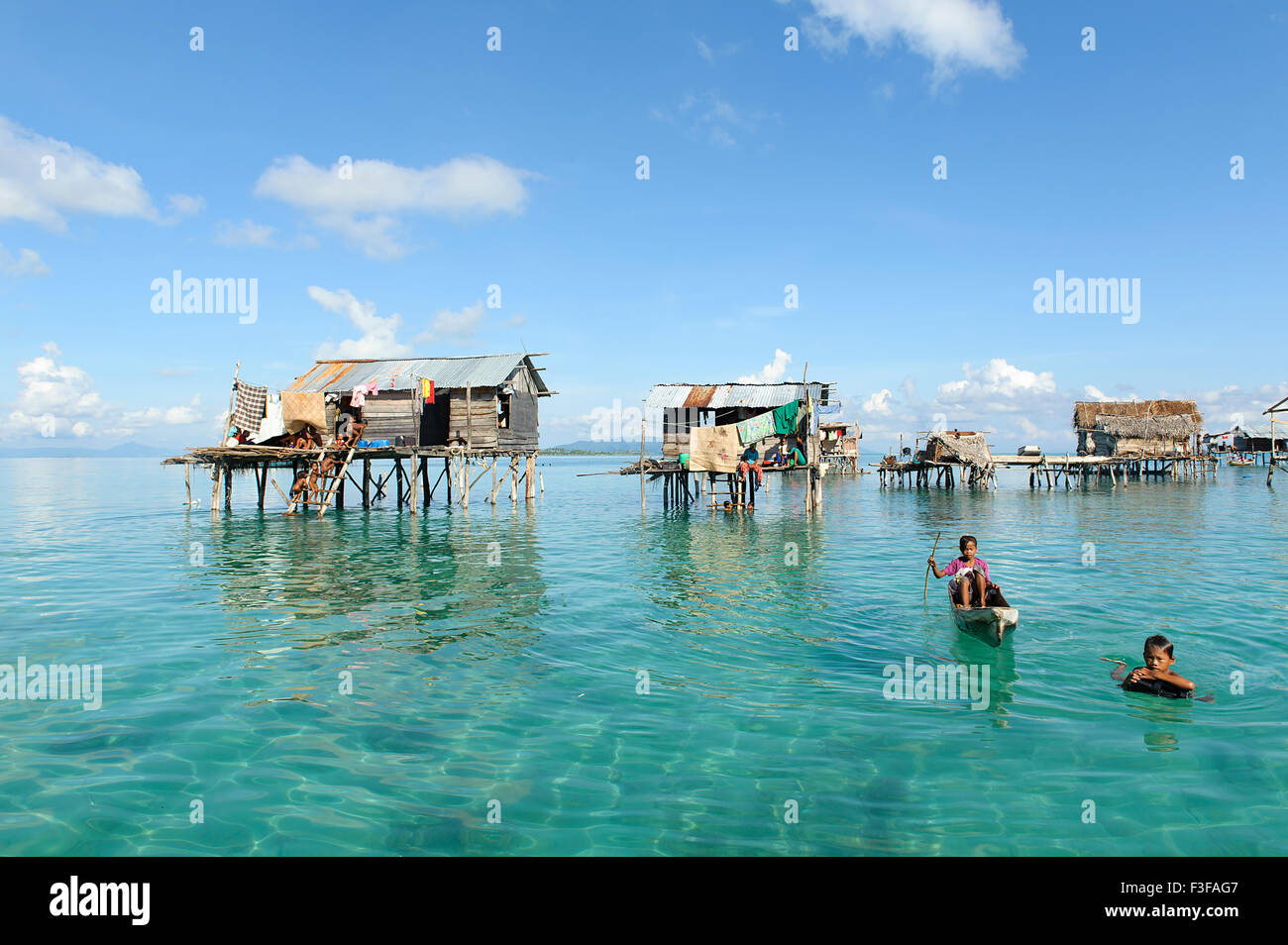 Unidentified Borneo Sea Gypsy kids on a canoes in Mabul Maiga Island ...