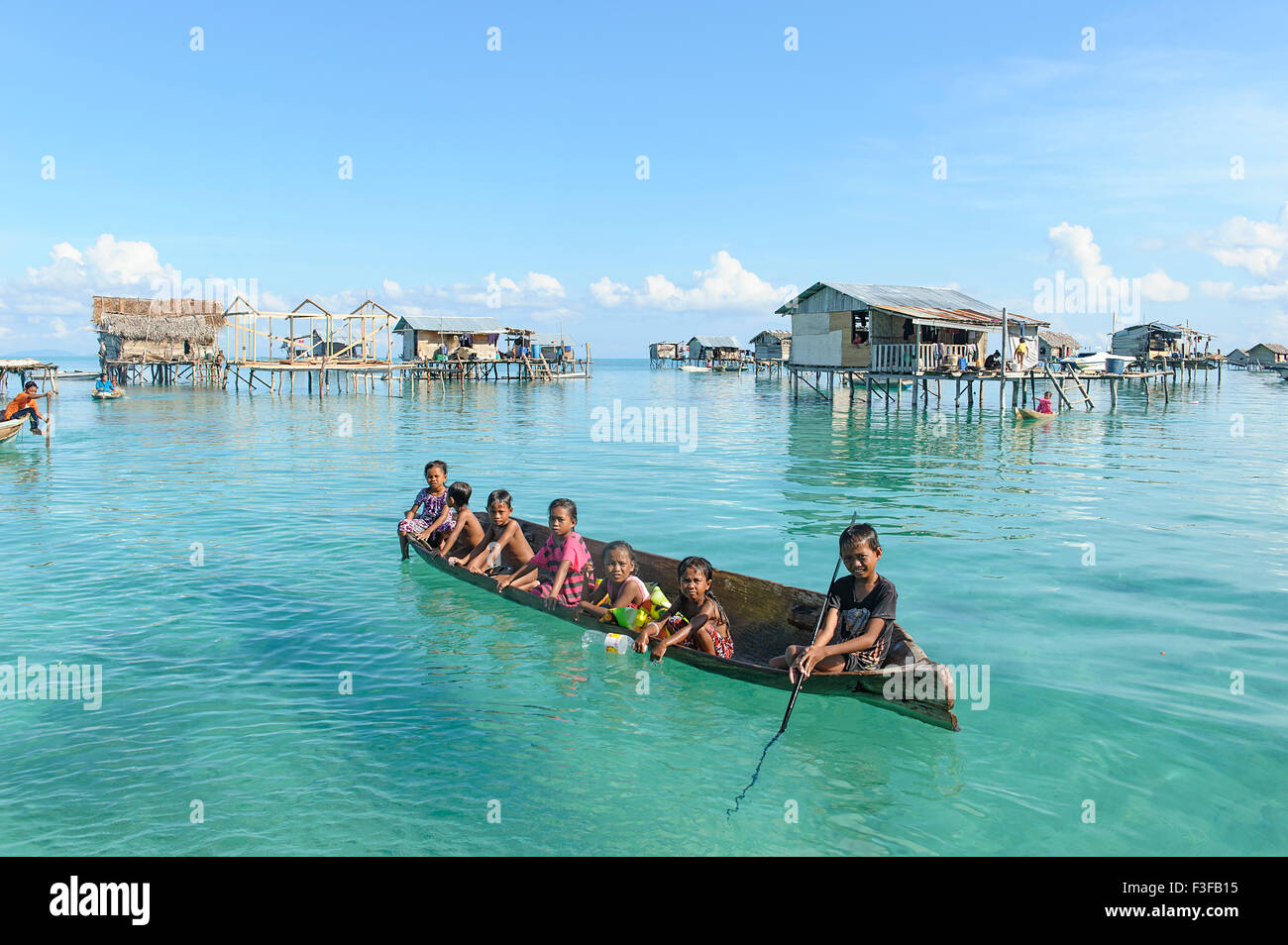 Unidentified Borneo Sea Gypsy kids on a canoes in Mabul Maiga Island ...