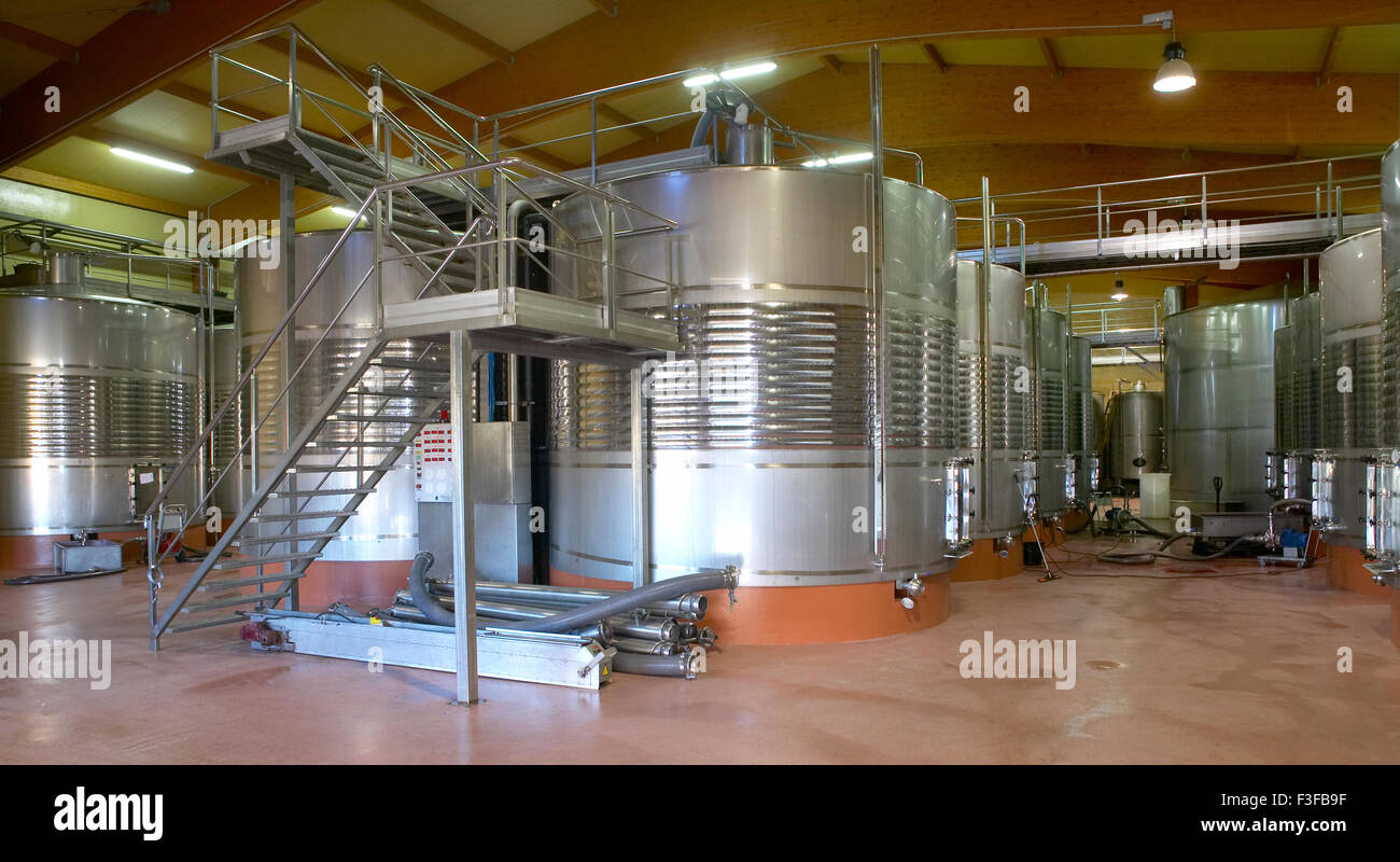 Winemaking industrial fermenting process in a steel barrels Stock Photo ...
