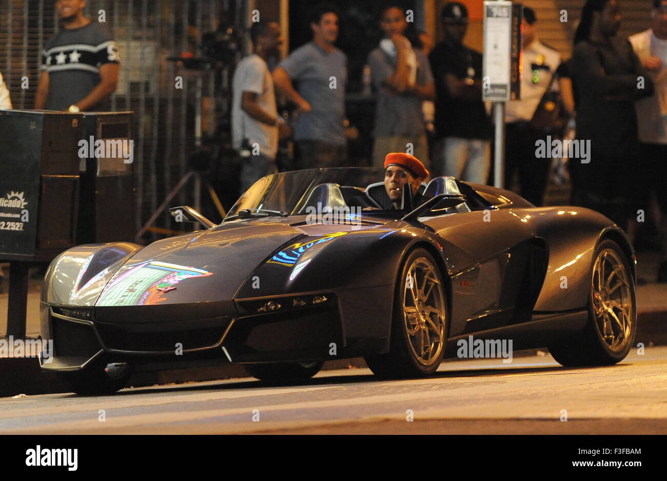 Singer Chris Brown hops out of a sports car on the set of his new music ...