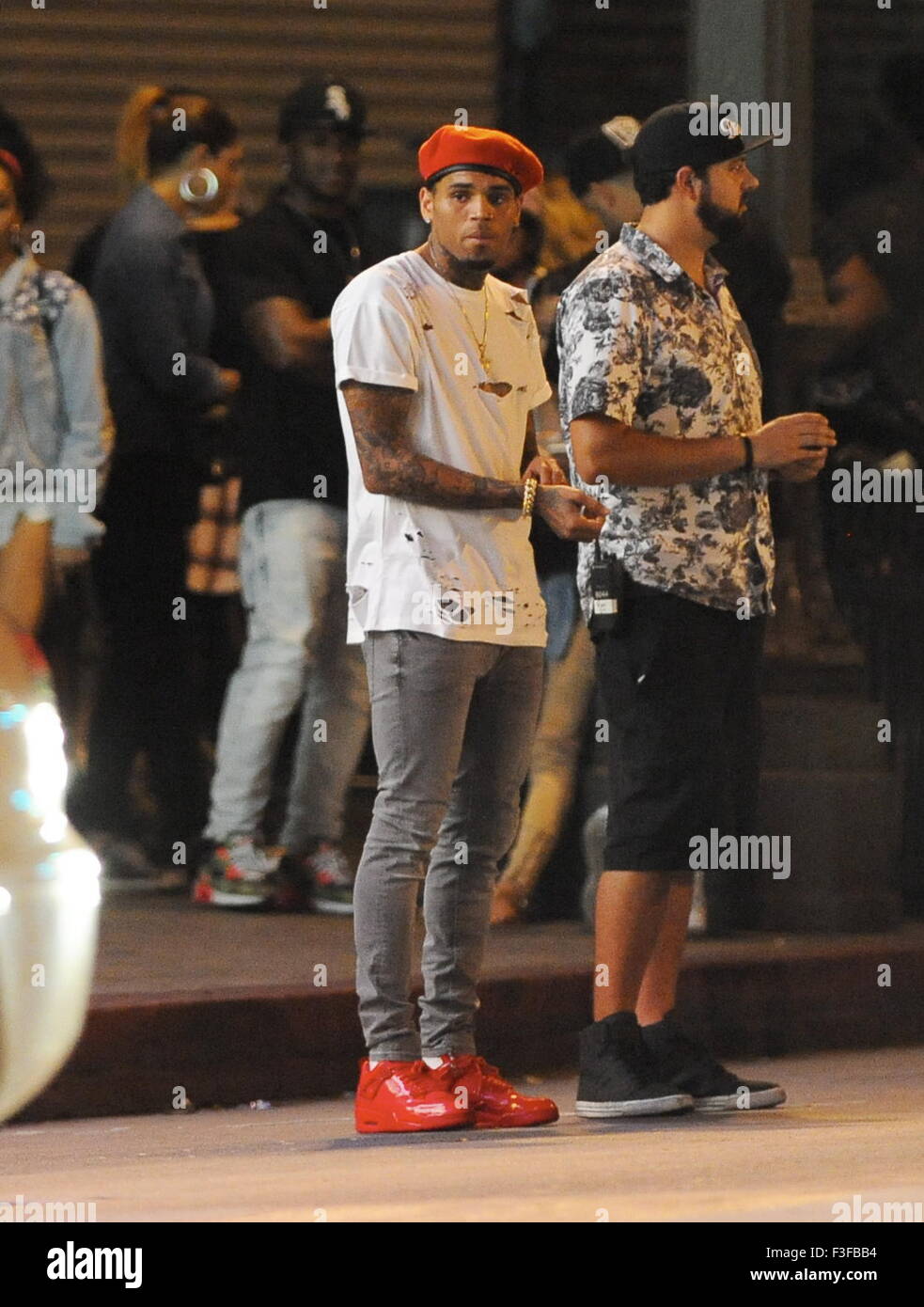 Singer Chris Brown hops out of a sports car on the set of his new music ...