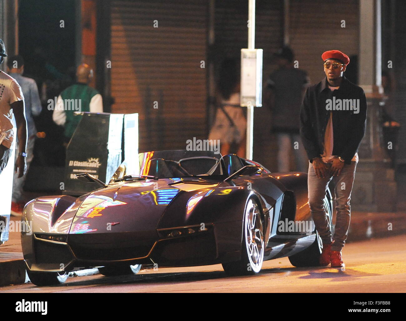 Singer Chris Brown hops out of a sports car on the set of his new music ...