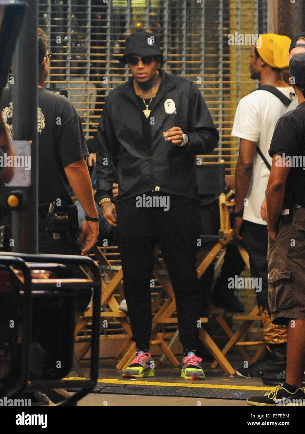 Singer Chris Brown hops out of a sports car on the set of his new music ...