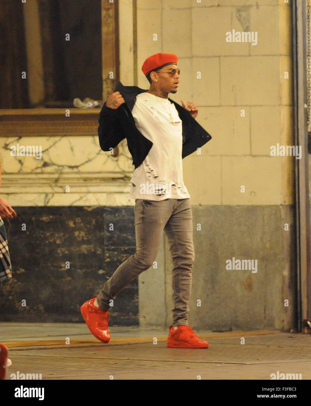 Singer Chris Brown hops out of a sports car on the set of his new music ...