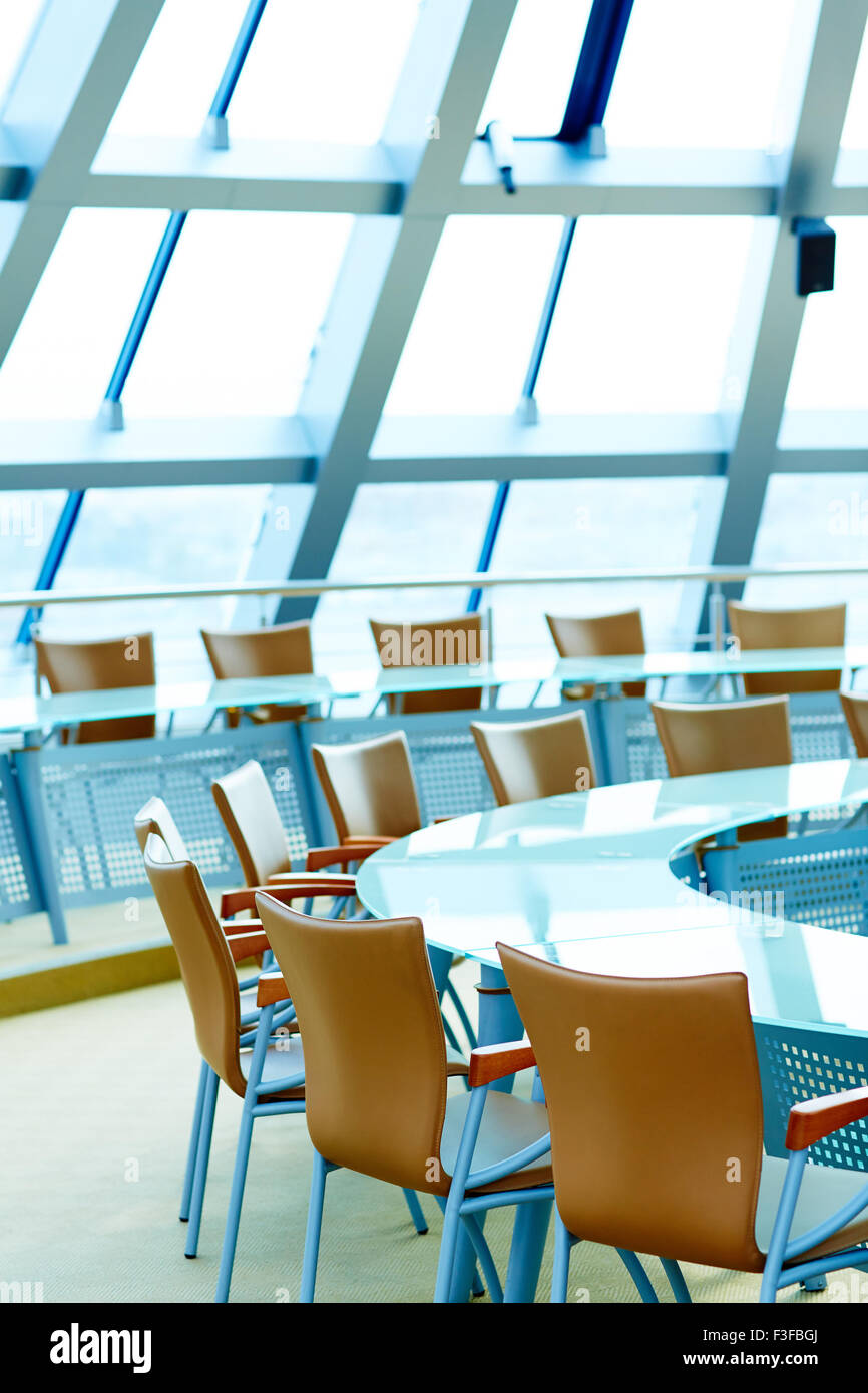 Empty conference hall with round table and chairs around it Stock Photo ...