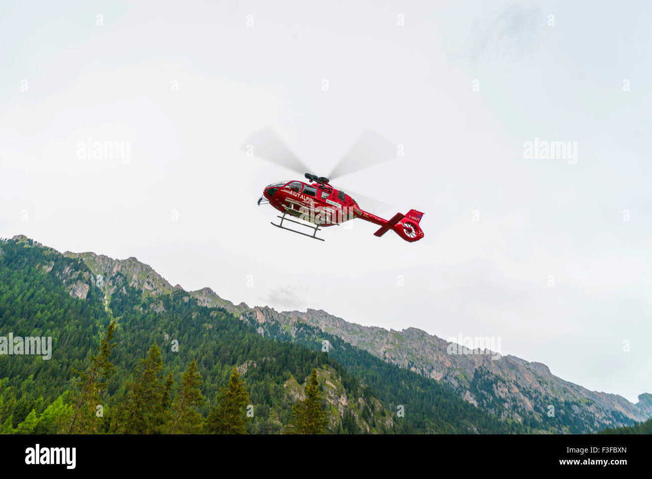 Red Aiut Alpin rescue helicopter I-AIUT taking off from meadow, Airbus ...