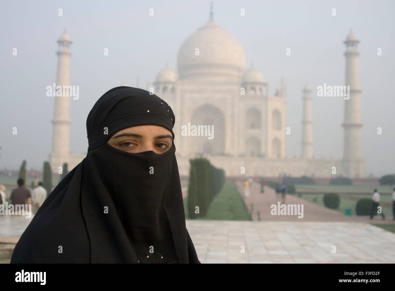 A Muslim woman in front of mogul monument Taj Mahal seven wonder of the ...