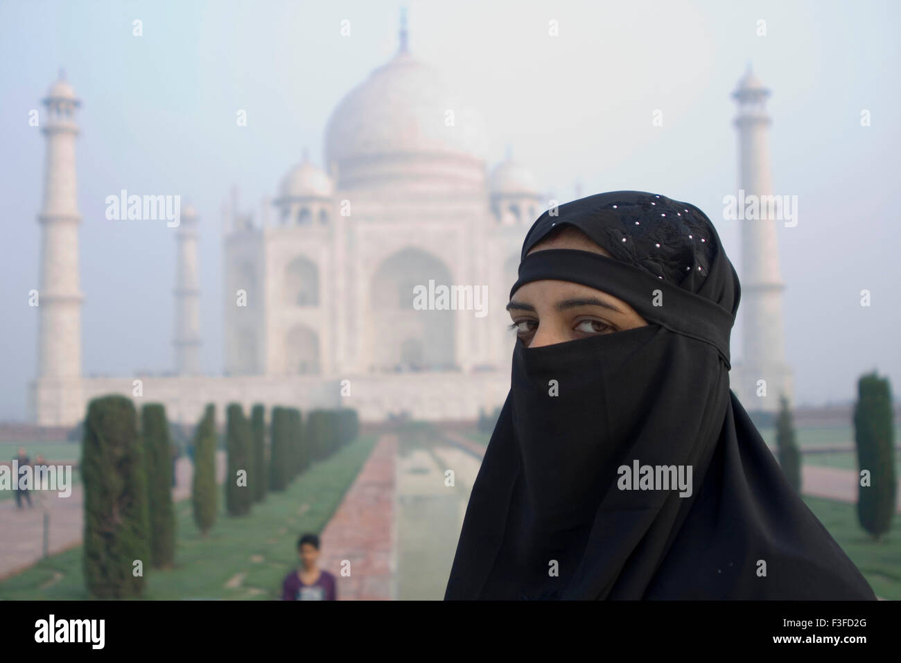 A Muslim woman in front of mogul monument Taj Mahal seven wonder of the ...