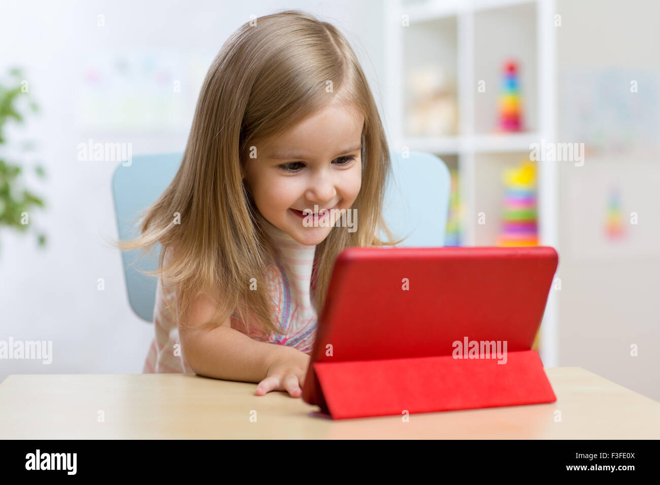 happy child little girl using tablet computer Stock Photo - Alamy
