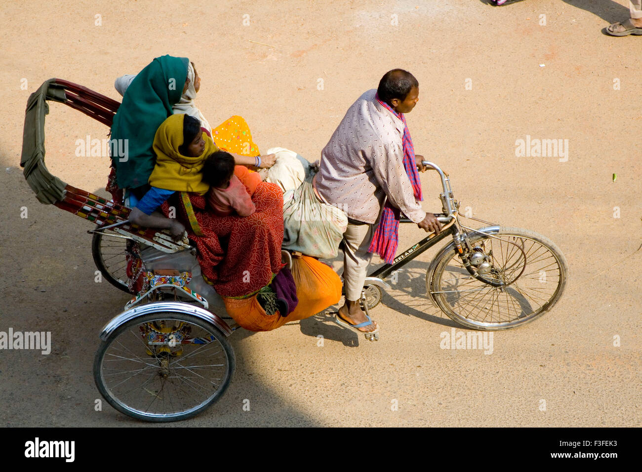 Passengers sitting in cycle rickshaw ; Varanasi ; Uttar Pradesh ; India ...