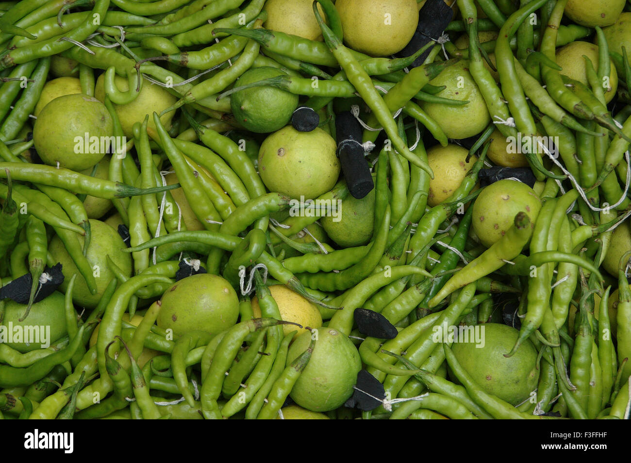 Belief ; Green Chili lemon charcoal tied together to protect from evil ...