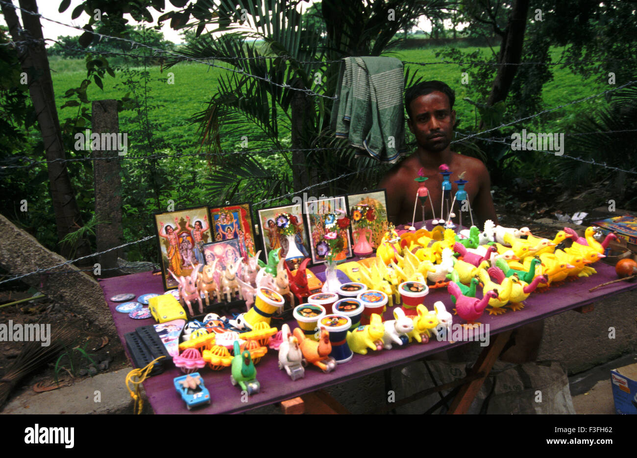 Indian Toy seller selling toy at Mayapur temple ; West Bengal ; India ...
