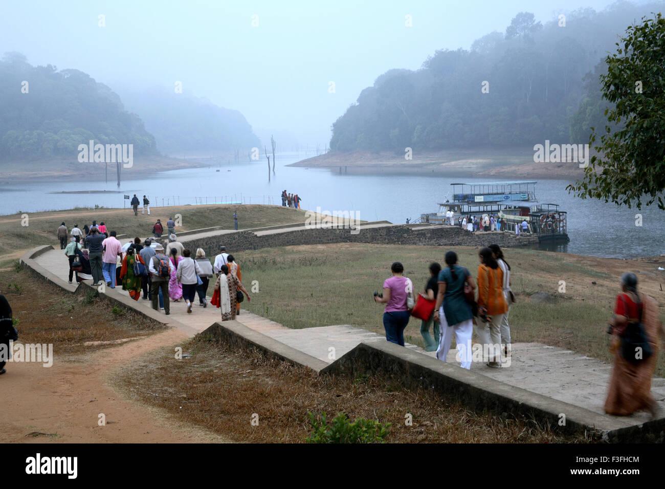 Early morning tourists going toward boat Jetty for boat ride at Periyar ...