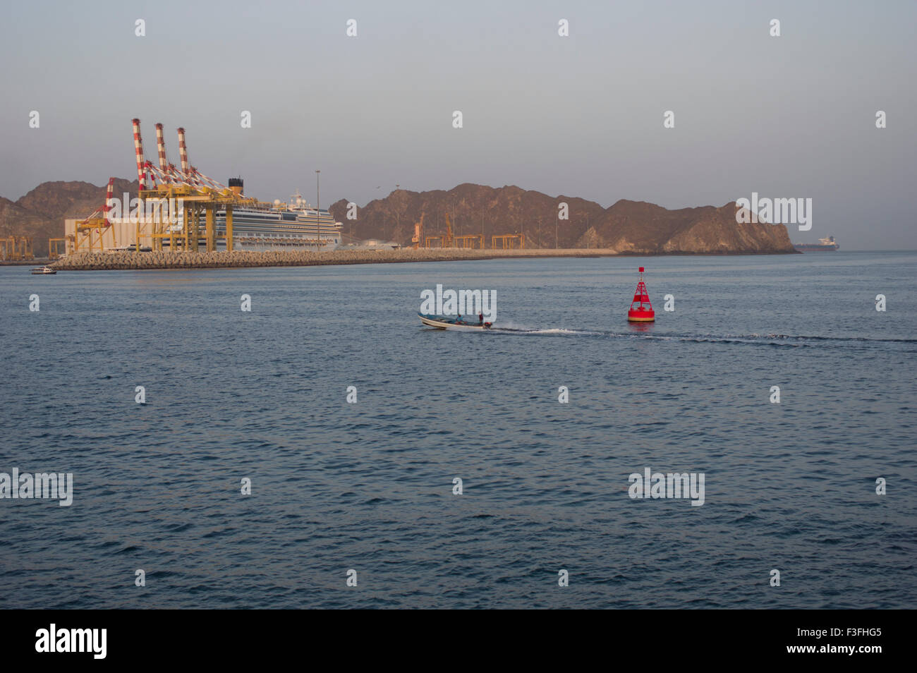Cruise ship and fishing boat in the harbour of Muscat in the Sultanate ...