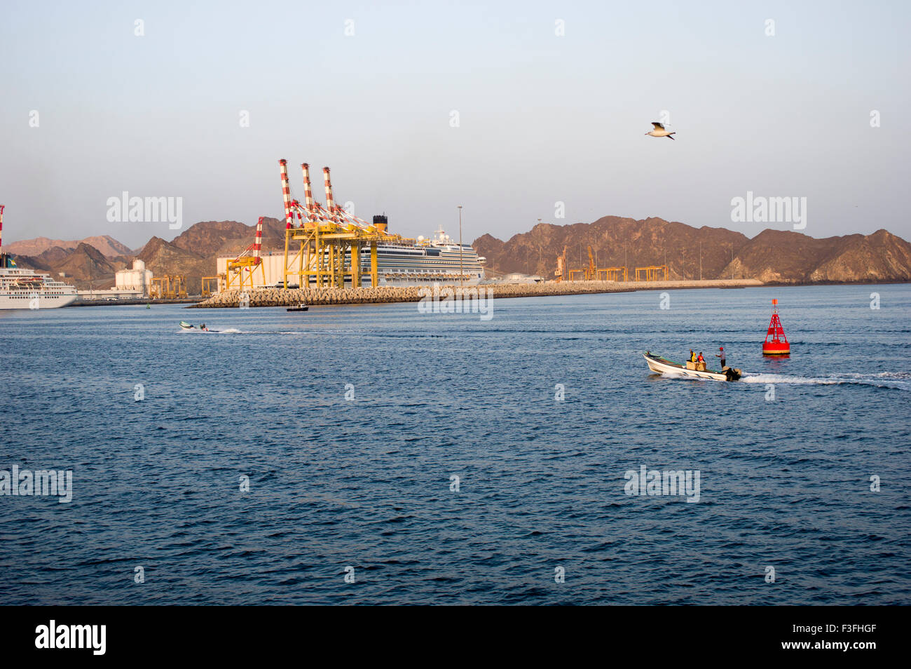 Cruise ship, the Sultan's yacht and a fishing boat in the harbour of ...